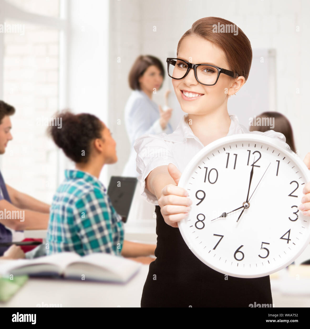 student showing clock Stock Photo - Alamy