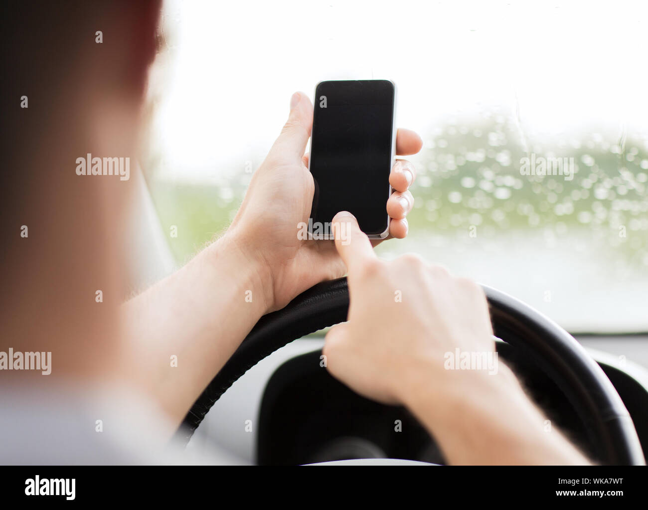 man using phone while driving the car Stock Photo - Alamy