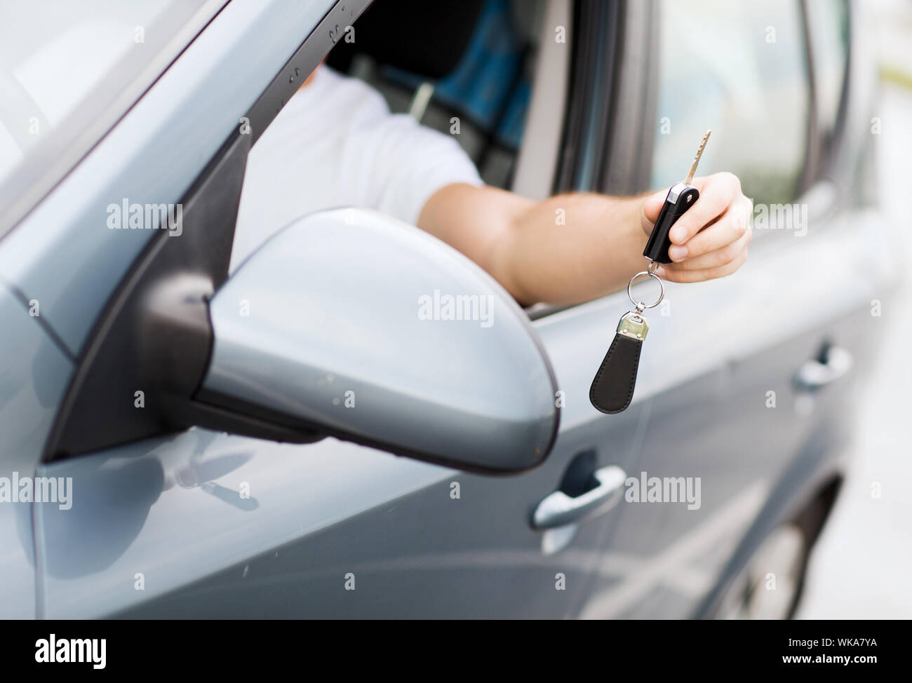 transportation and ownership concept - man with car key outside Stock ...