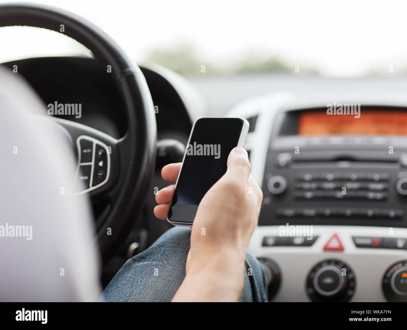 man using phone while driving the car Stock Photo - Alamy