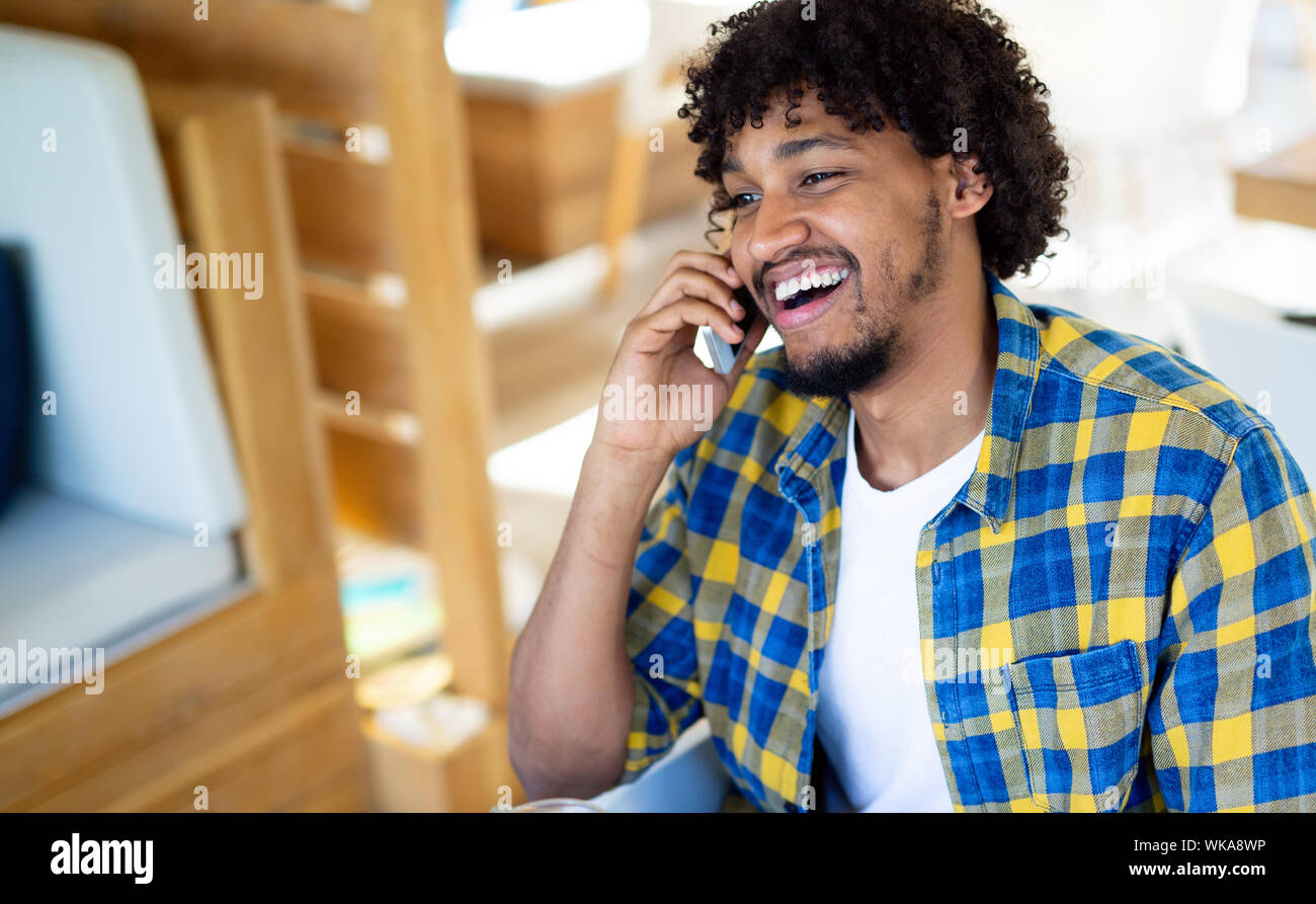 Happy african guy talking hi-res stock photography and images - Alamy