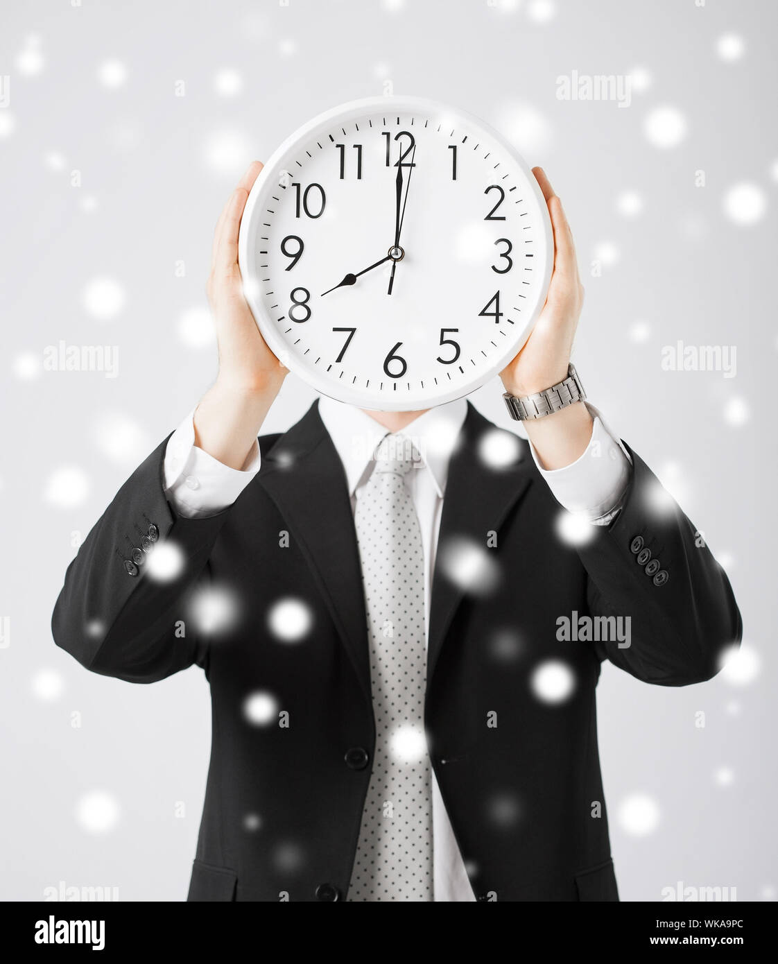 man covering his face with wall clock Stock Photo - Alamy