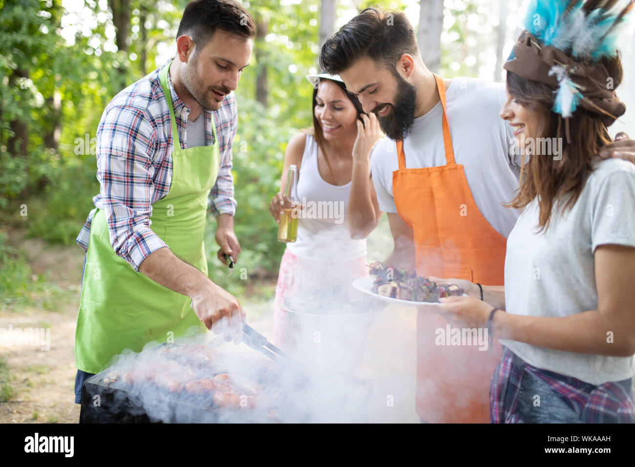 Group of friends having barbecue party in nature Stock Photo - Alamy