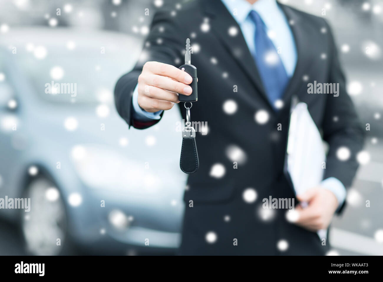 transportation and ownership concept - man with car key outside Stock ...