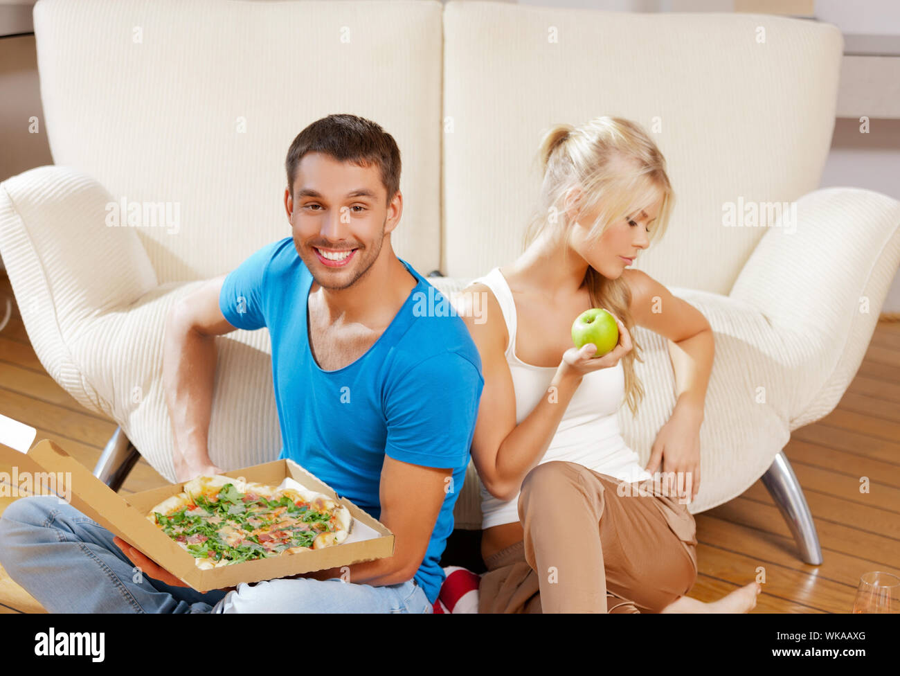 couple eating different food Stock Photo - Alamy