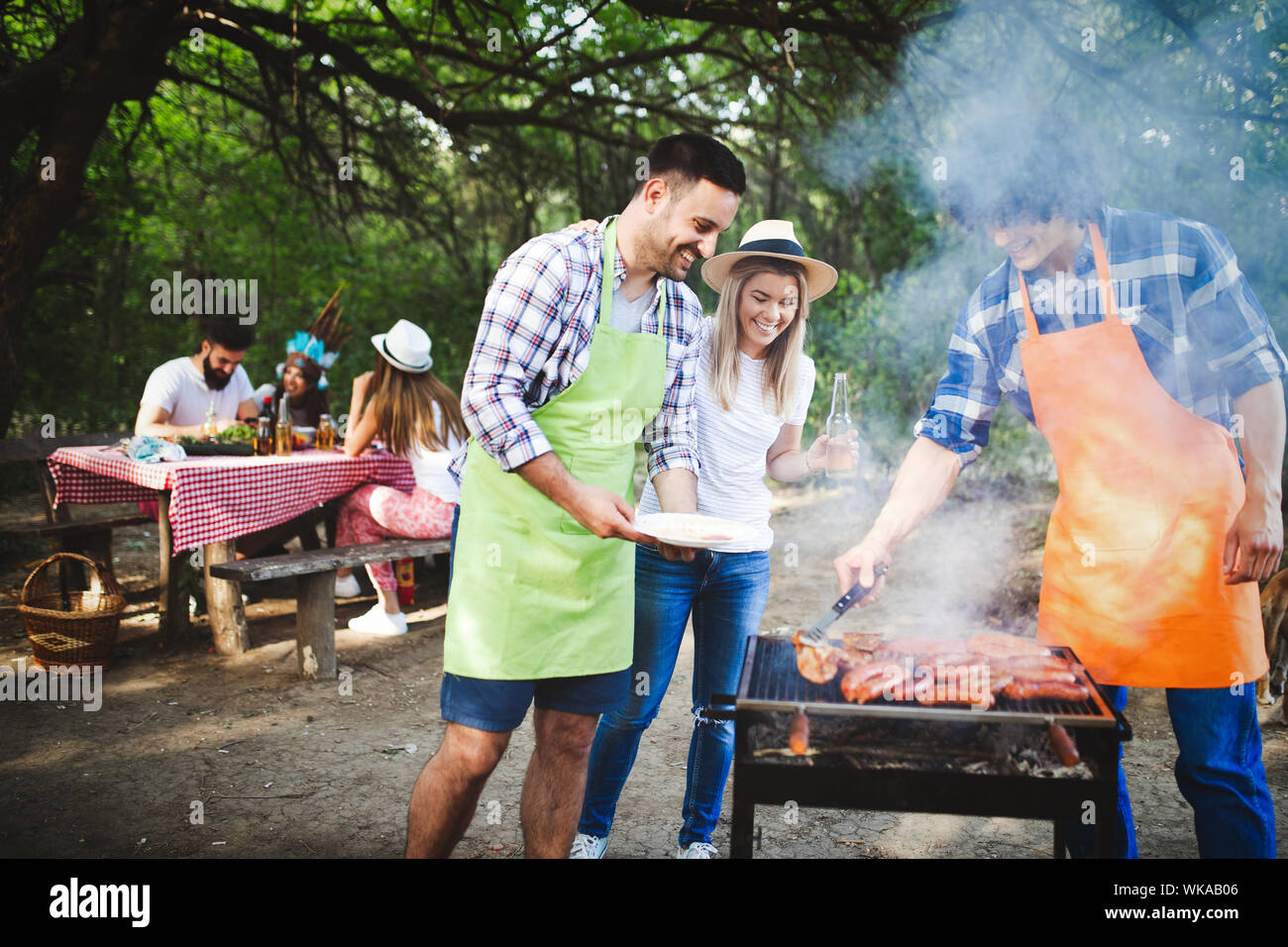 Group of friends having a barbecue party in nature Stock Photo - Alamy