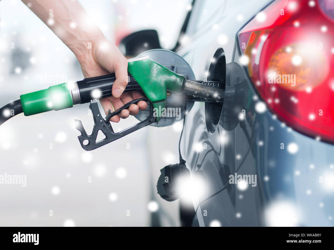 transportation and ownership concept - man pumping gasoline fuel in car ...