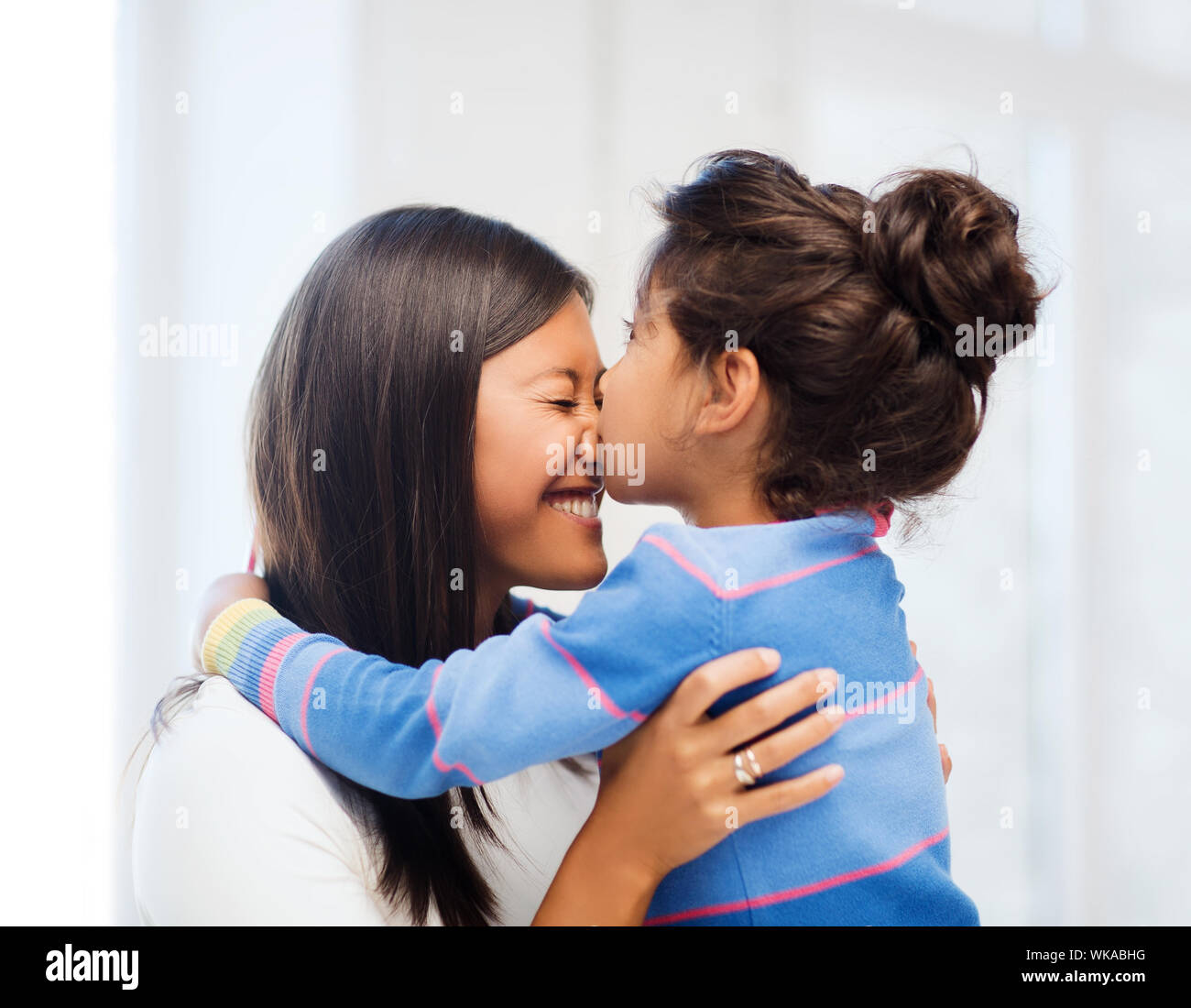 family, children and happy people concept - hugging mother and daughter ...