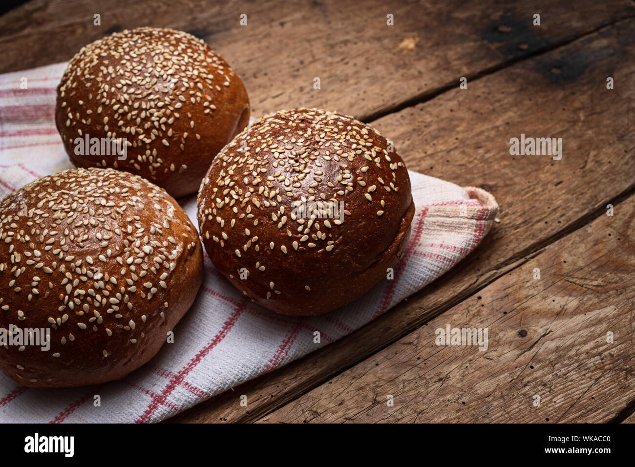 Homemade sourdough bread, round buns on vintage kitchen towel and ...