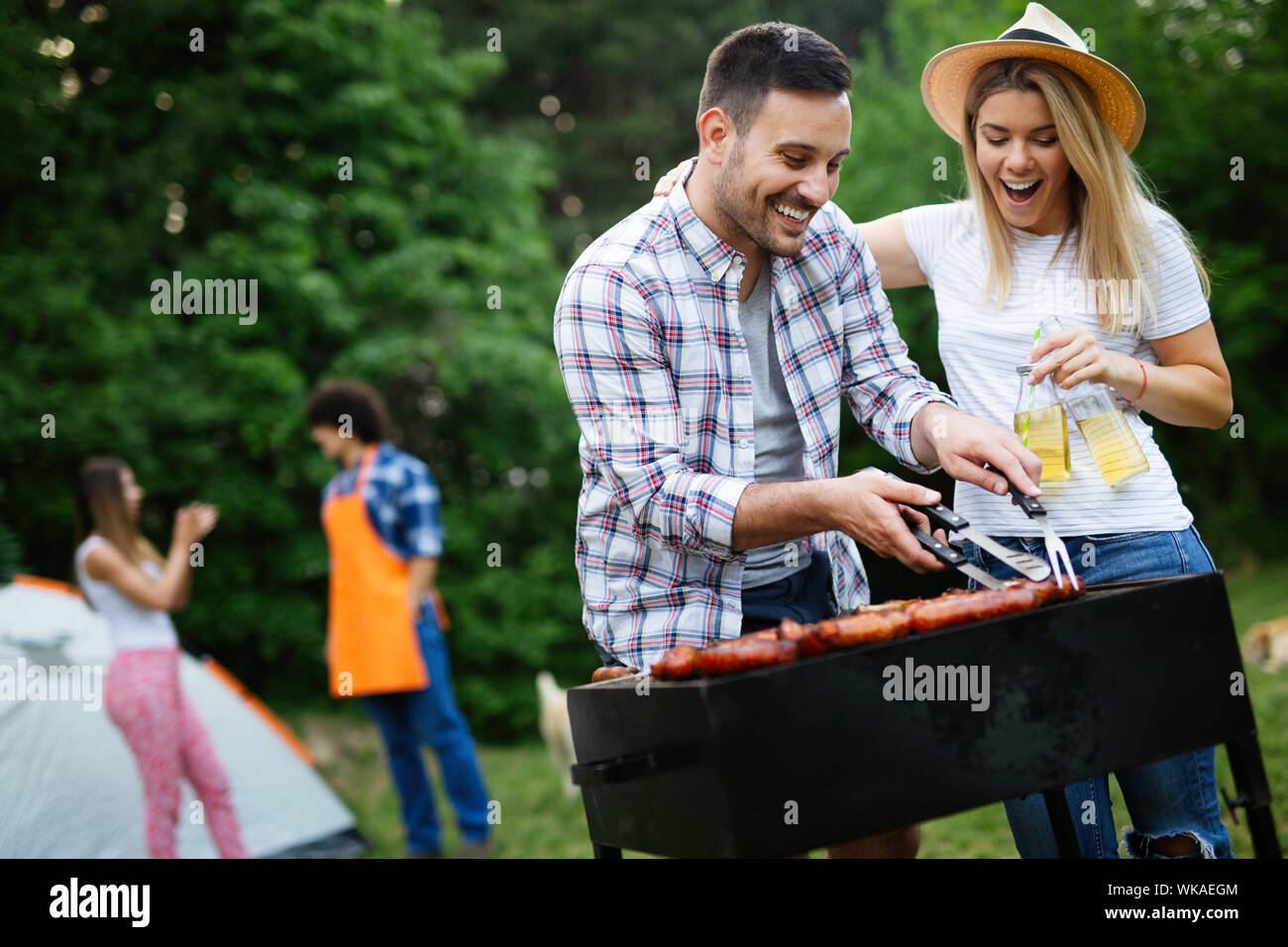 Group of friends having a barbecue and grill party in nature Stock ...