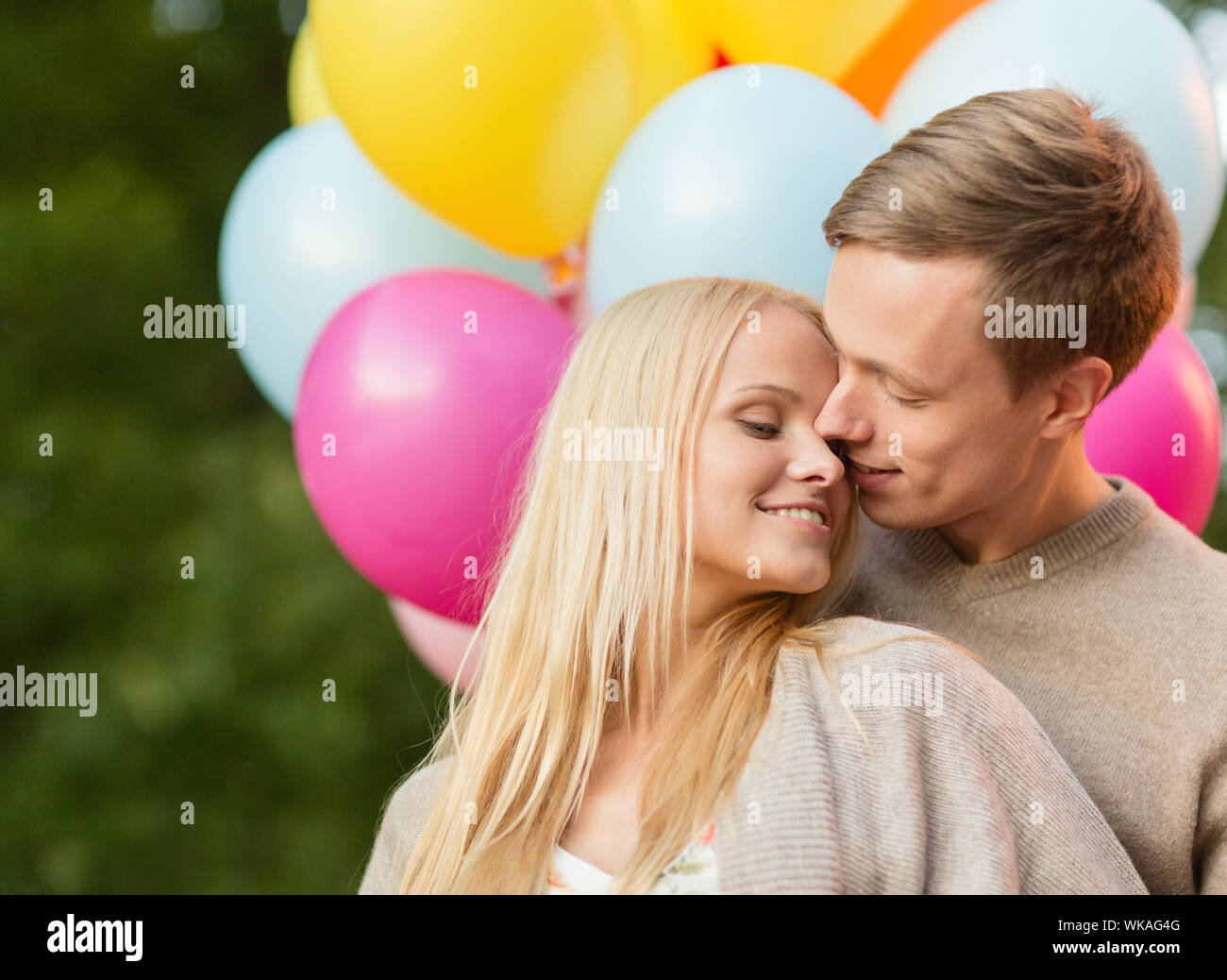 couple with colorful balloons kissing in the park Stock Photo - Alamy