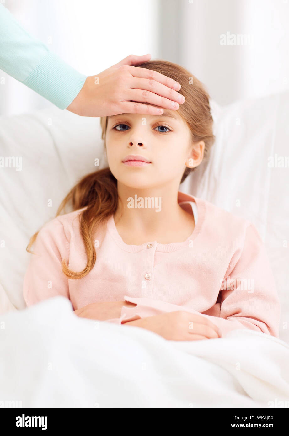 ill girl child and caring mother Stock Photo - Alamy