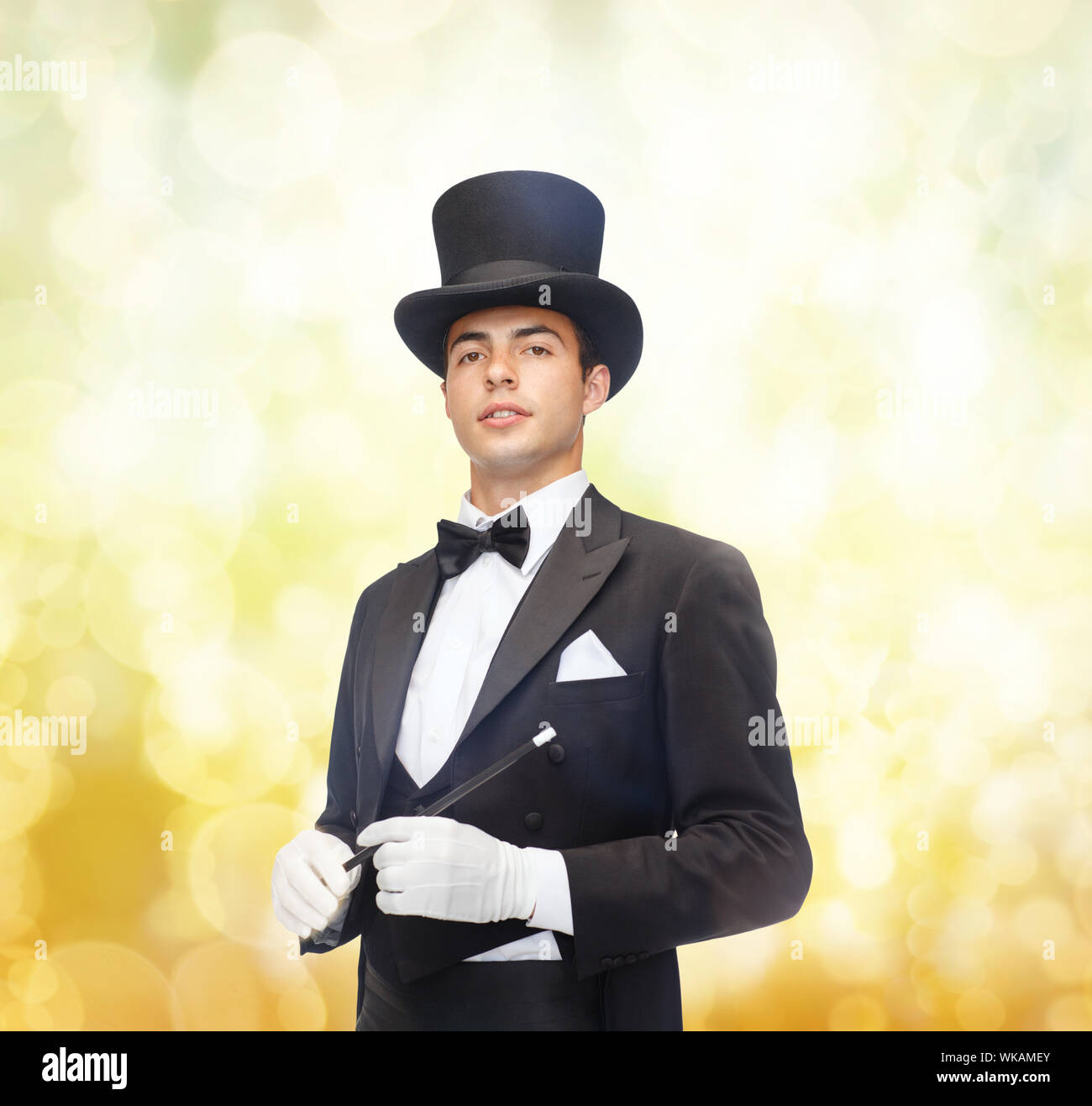 performance, circus, show concept - magician in top hat with magic wand ...