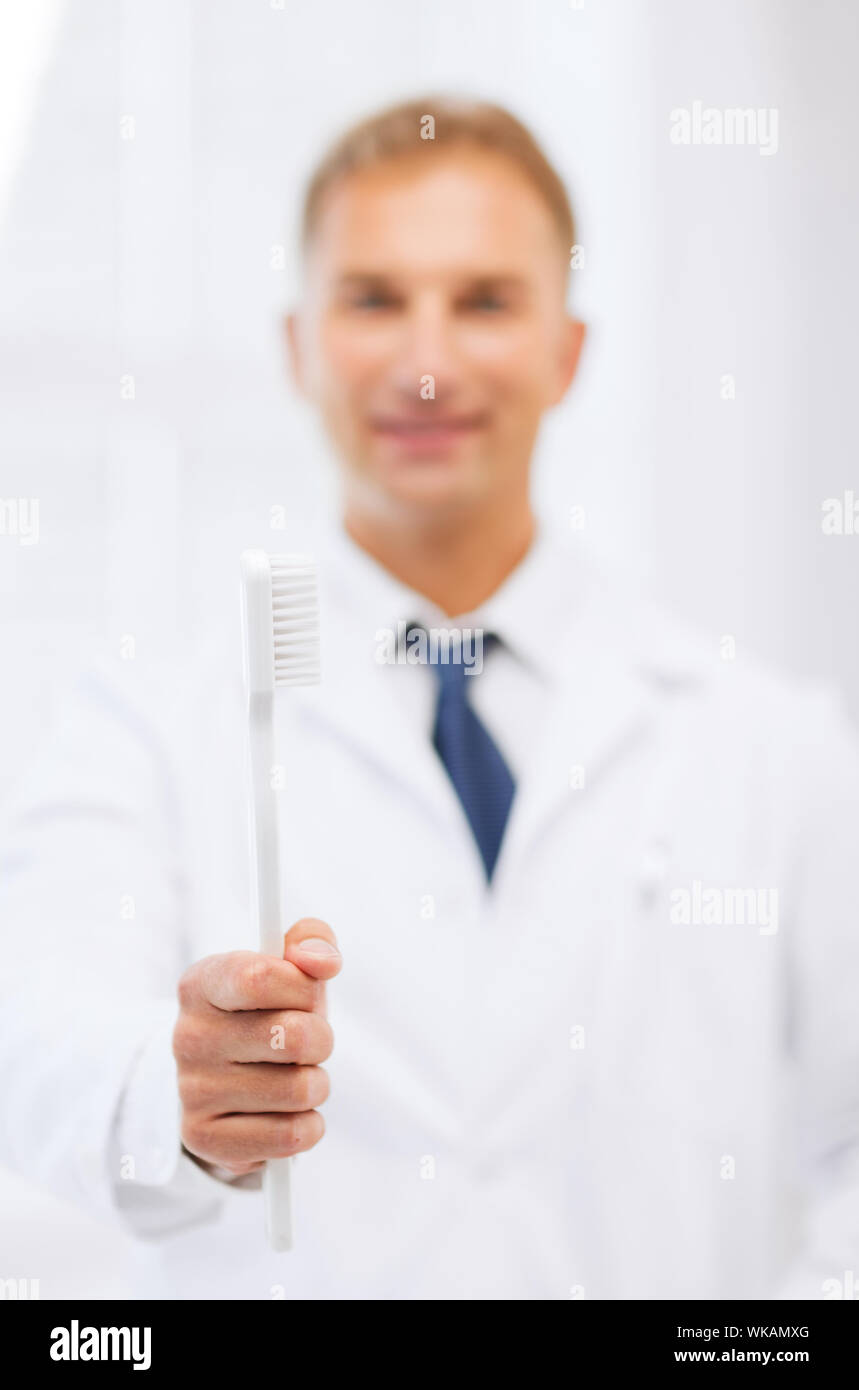 healthcare, medical and stomatology - dentist with toothbrush in ...