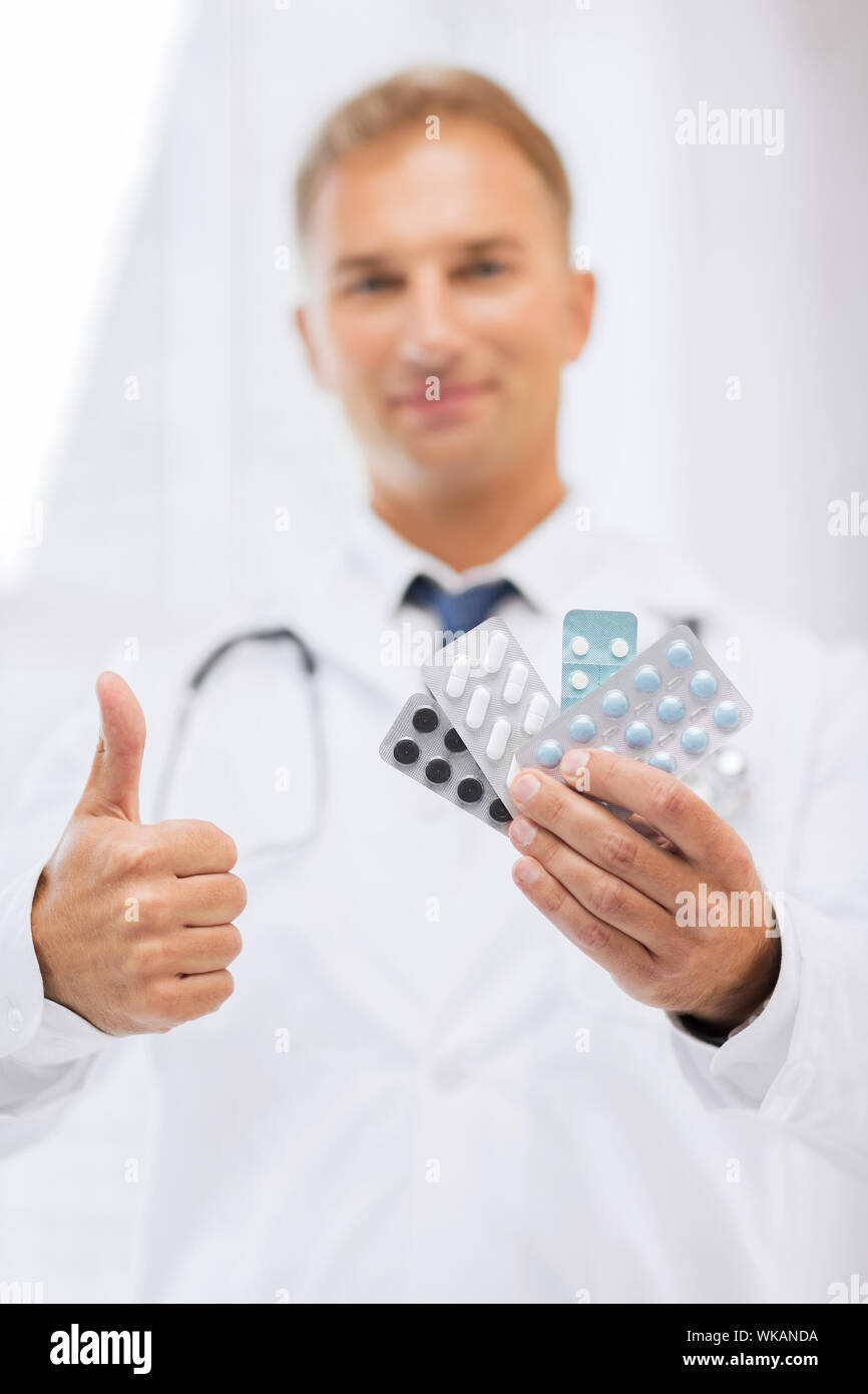 male doctor with packs of pills Stock Photo - Alamy