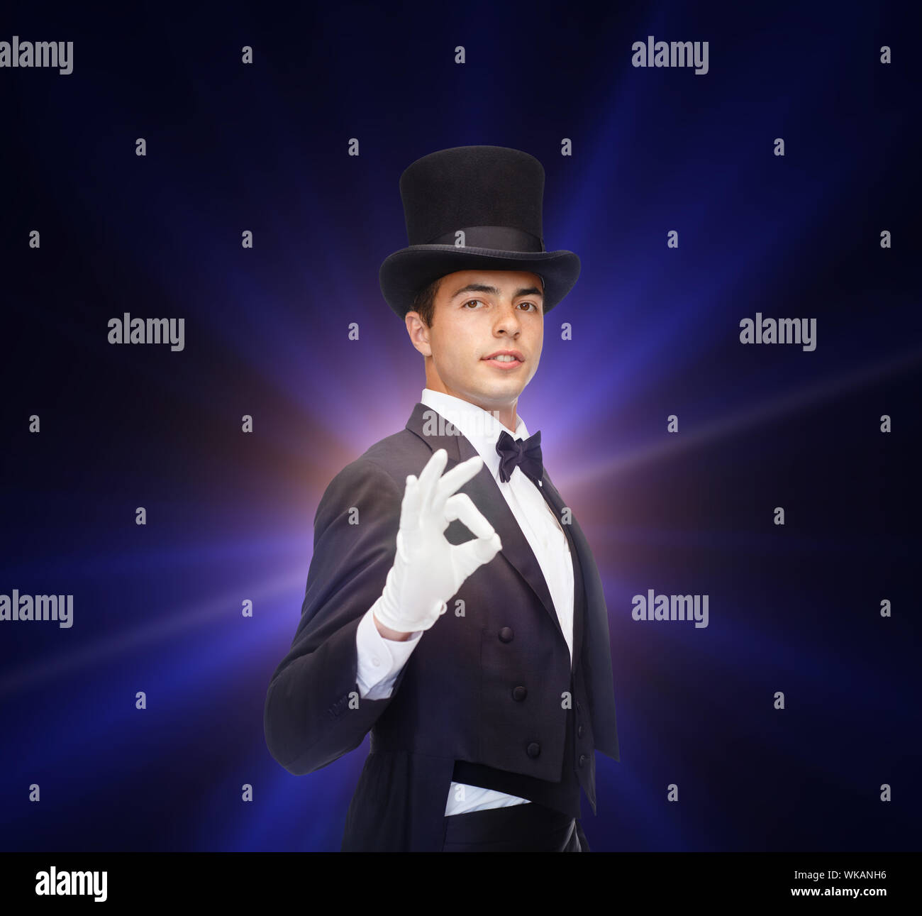 magic, performance, circus, show concept - magician in top hat showing ...