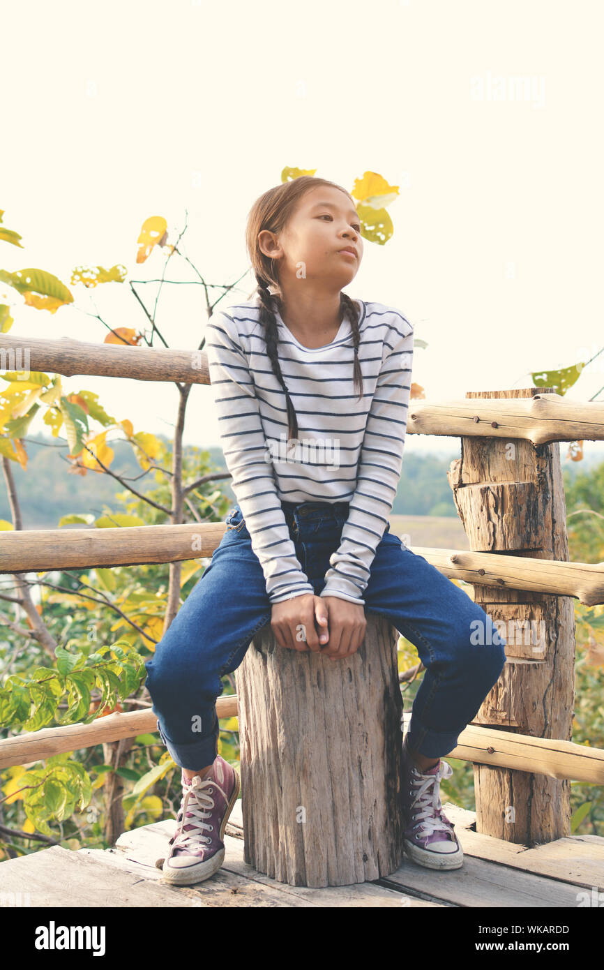 Girl sitting on tree hi-res stock photography and images - Alamy