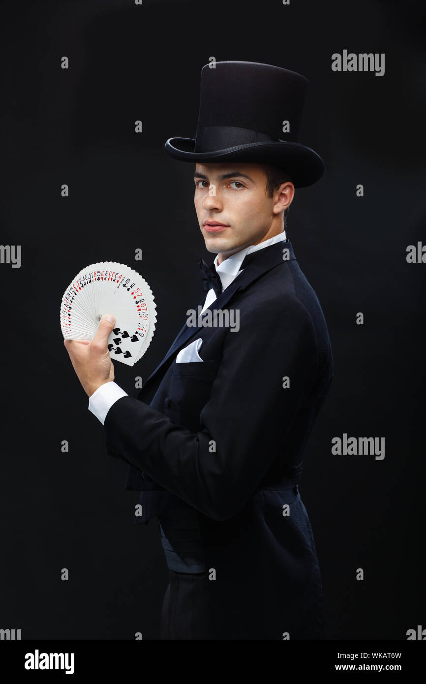 Magician showing trick playing cards hi-res stock photography and ...