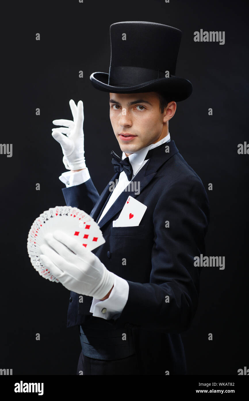 magician showing trick with playing cards Stock Photo - Alamy