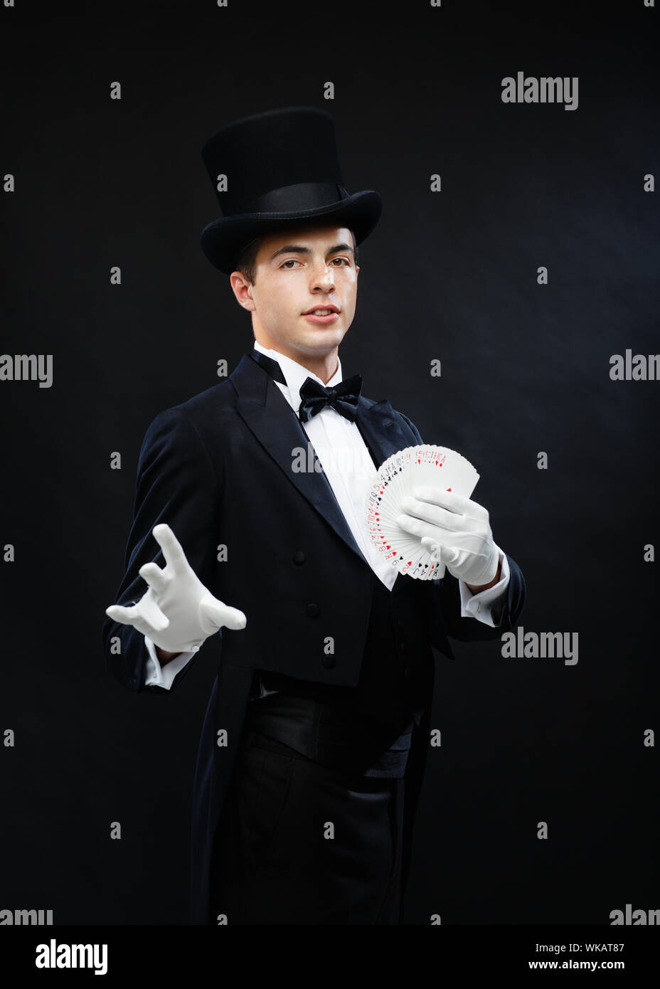 magician showing trick with playing cards Stock Photo - Alamy