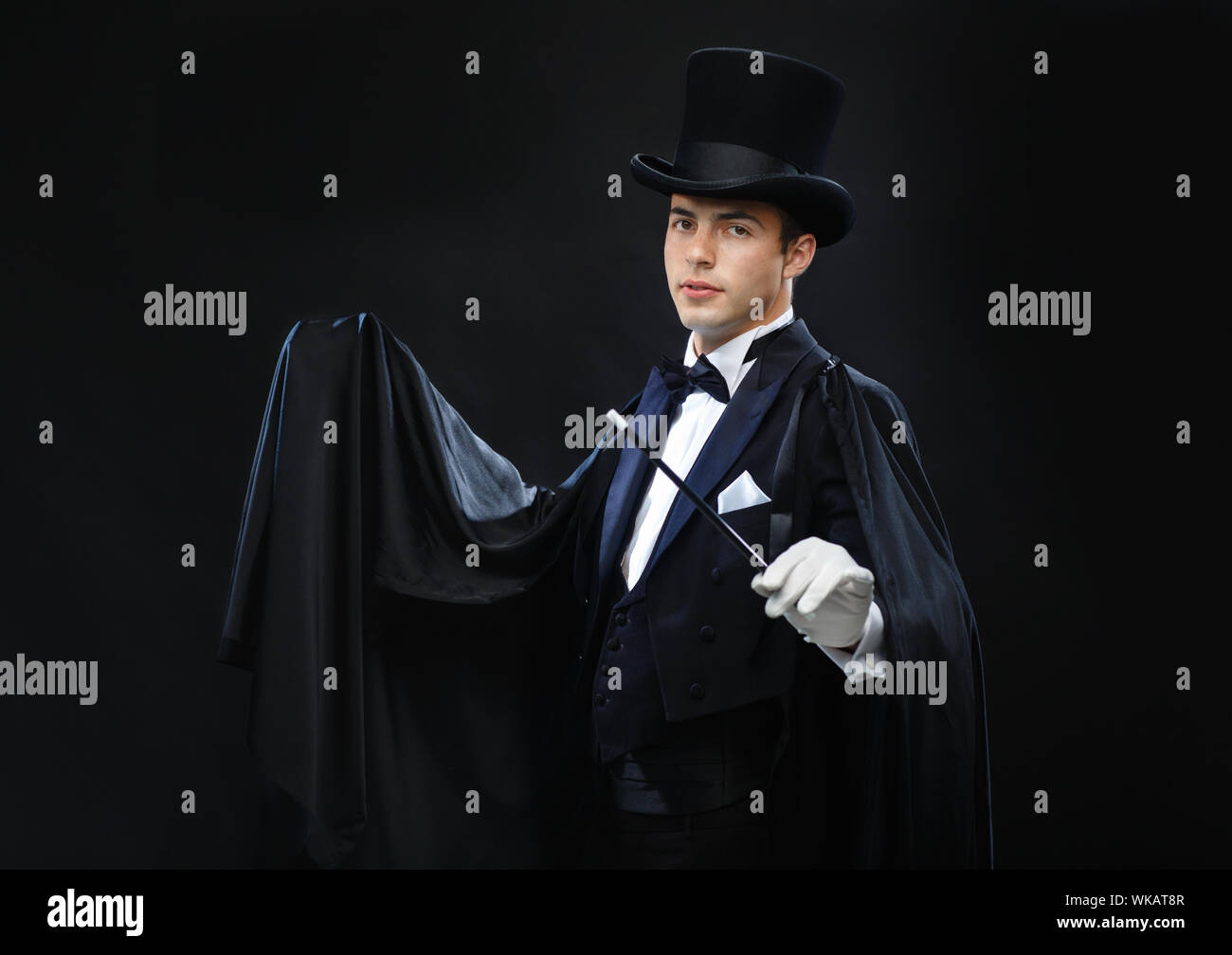 performance, circus, show concept - magician in top hat with magic wand ...