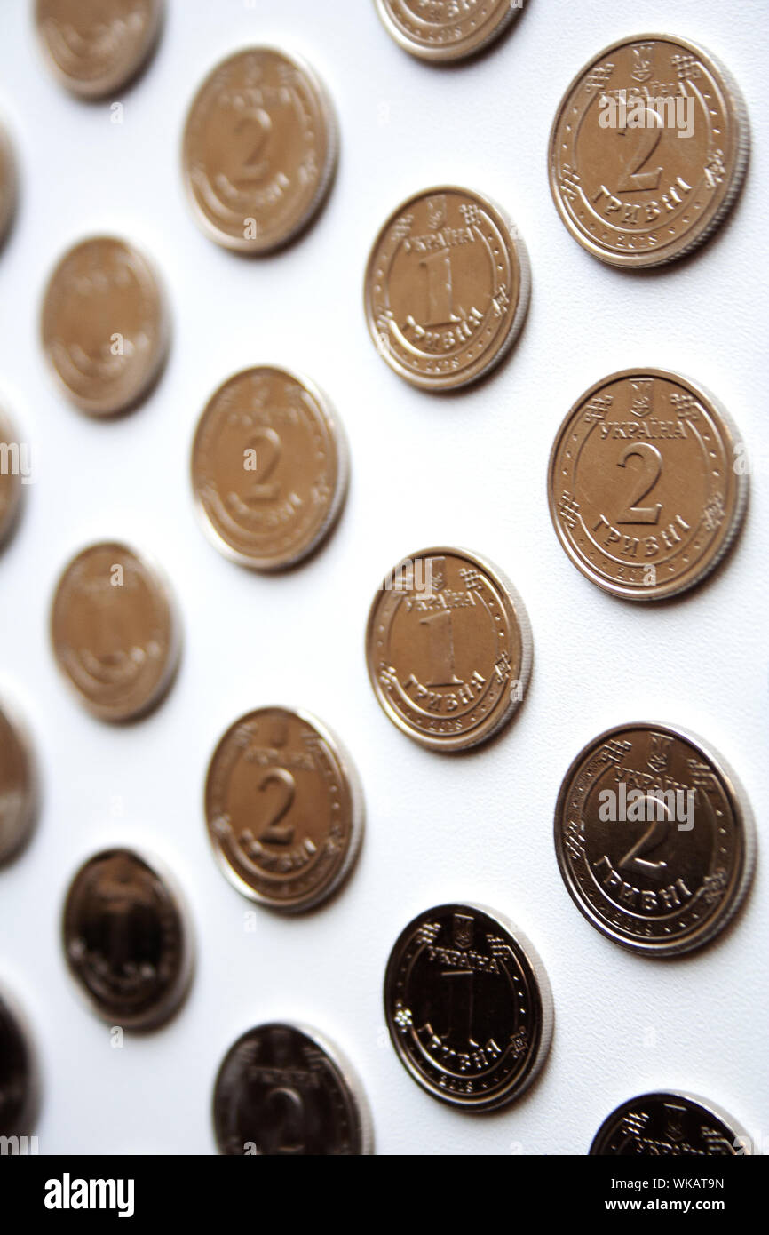 Silver coins pattern of one and two Ukrainian hryvnias on white ...