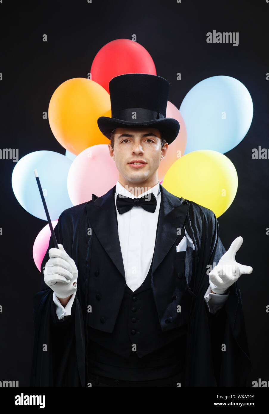 magician in top hat with magic wand showing trick Stock Photo - Alamy
