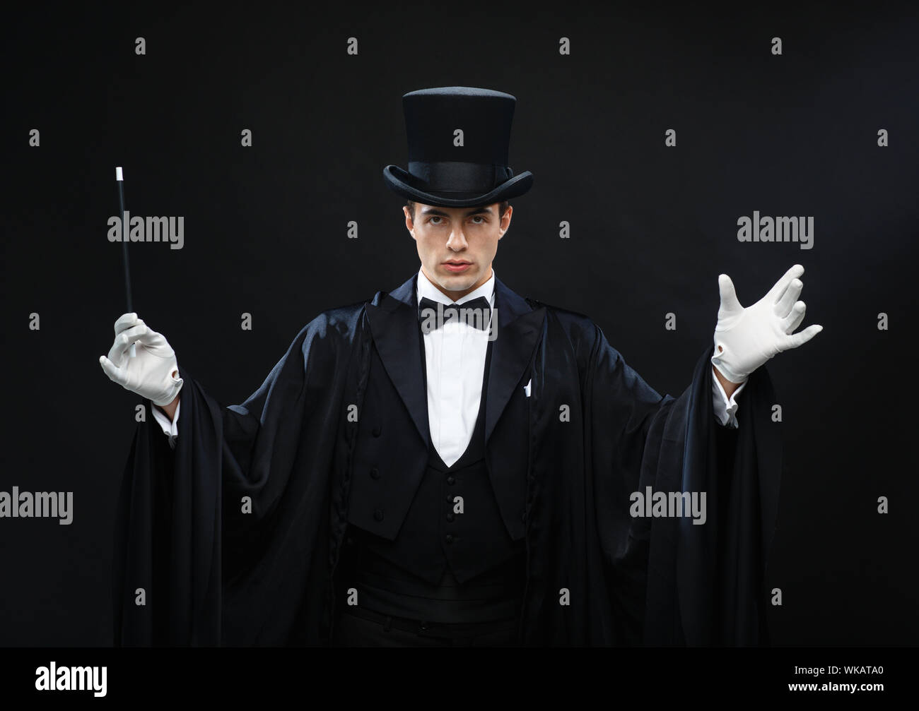 performance, circus, show concept - magician in top hat with magic wand ...