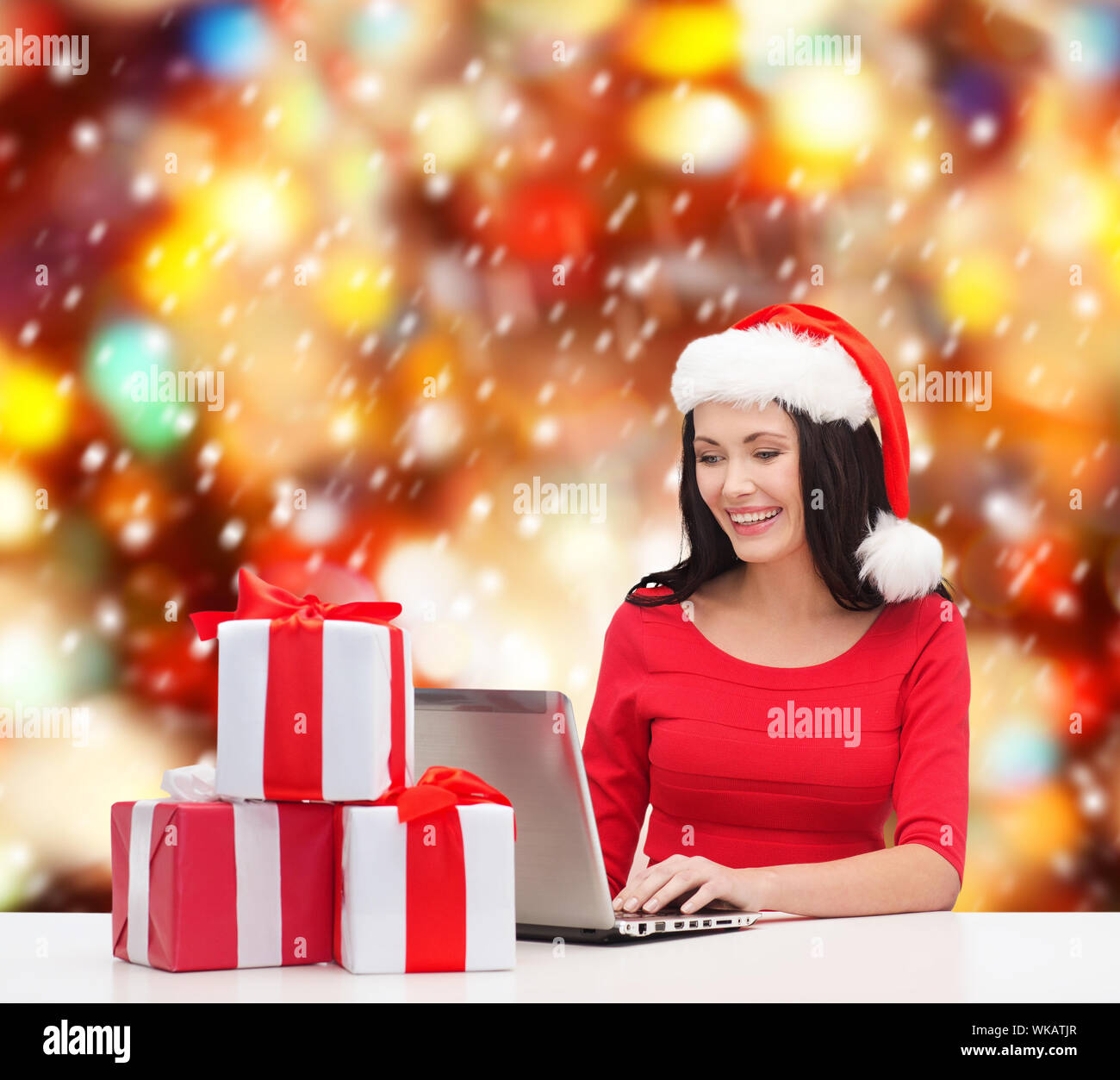 woman with gift boxes and laptop computer Stock Photo - Alamy
