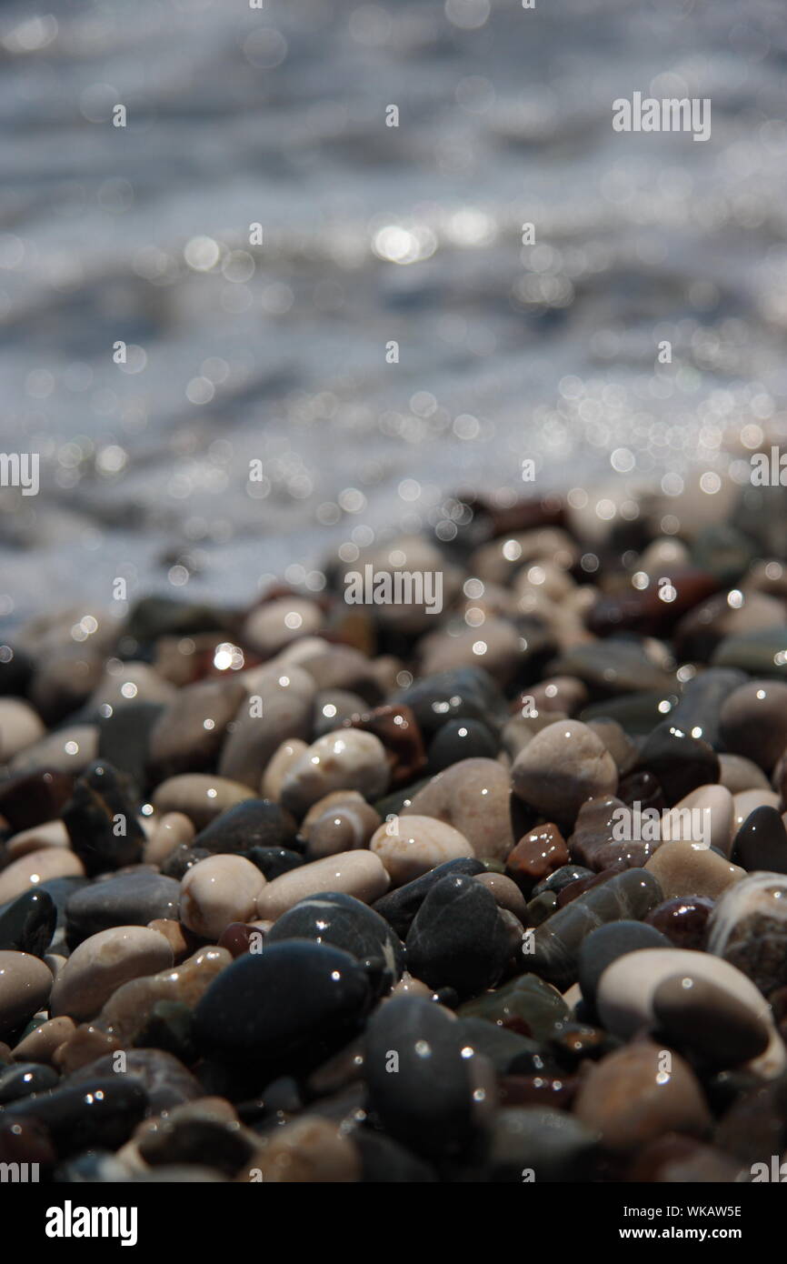 Wet pebbles on sea coast Stock Photo - Alamy