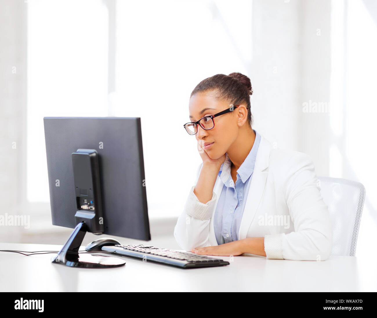 business and internet concept - african businesswoman with computer in ...