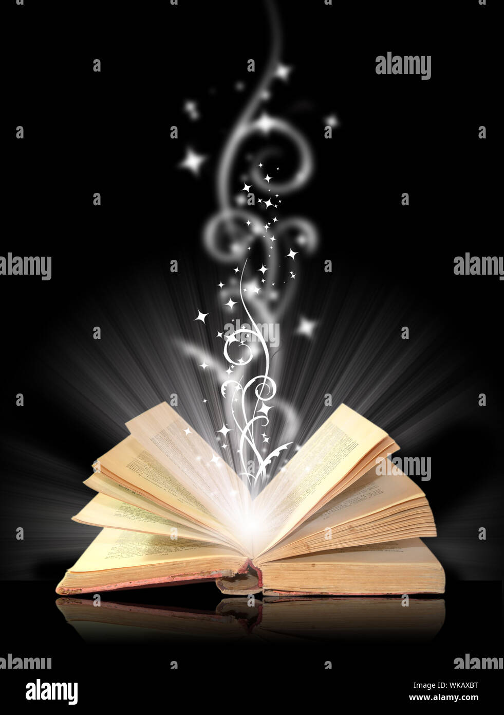 Open book magic on black Stock Photo - Alamy