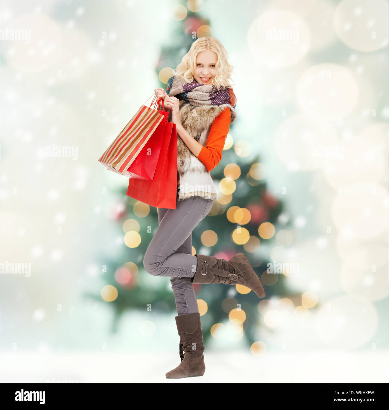 retail and sale concept - happy teenage girl in winter clothes with ...