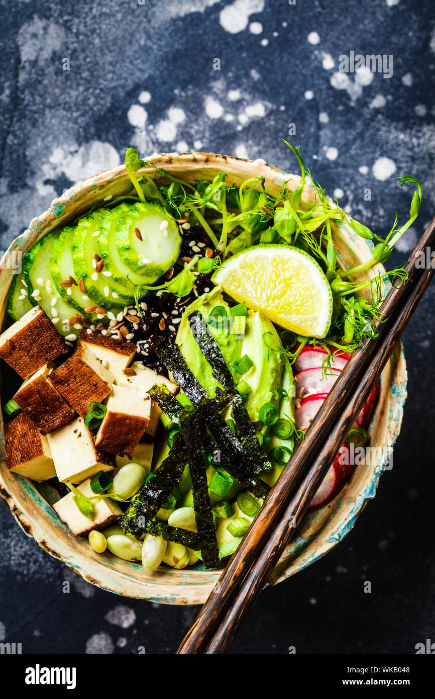 Poke bowl with avocado, black rice, smoked tofu, beans, vegetables ...