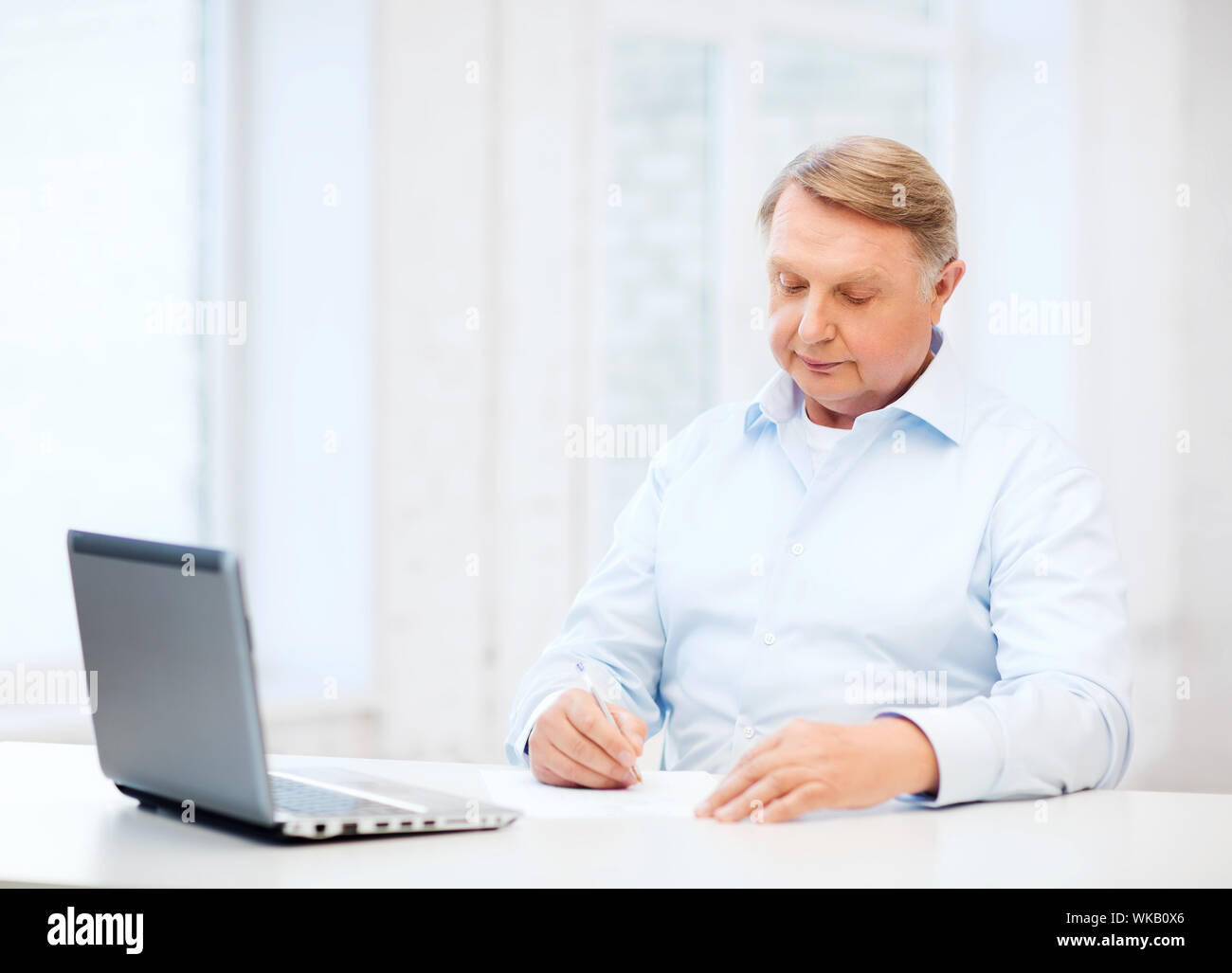 business, tax, office, school and education concept - old man filling a ...
