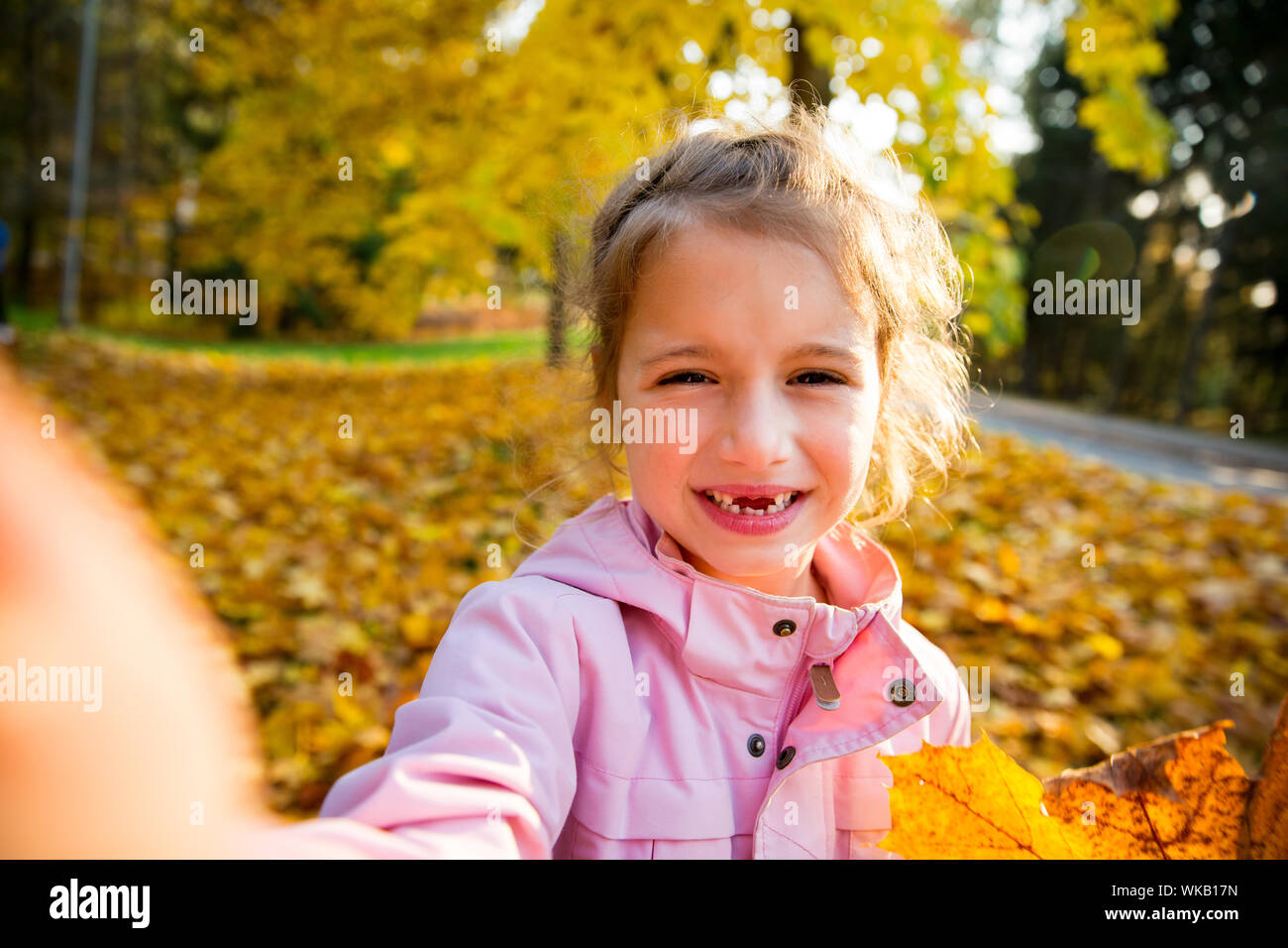 Cute little girl with missing teeth taking selfie. Happy child laughing ...