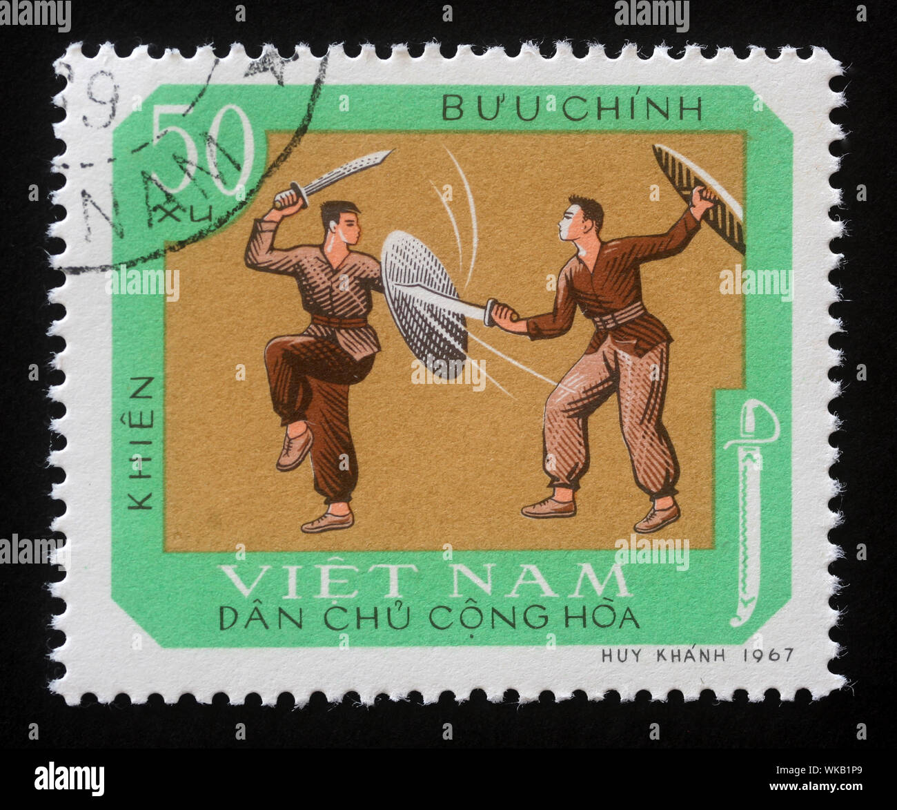Stamp printed in Vietnam shows Duel with sword and shields, traditional ...