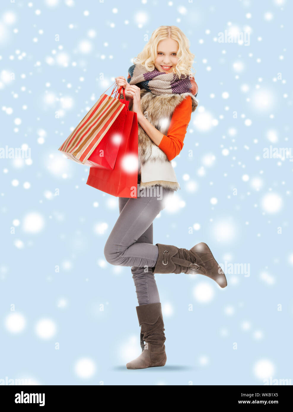 retail and sale concept - happy teenage girl in winter clothes with ...