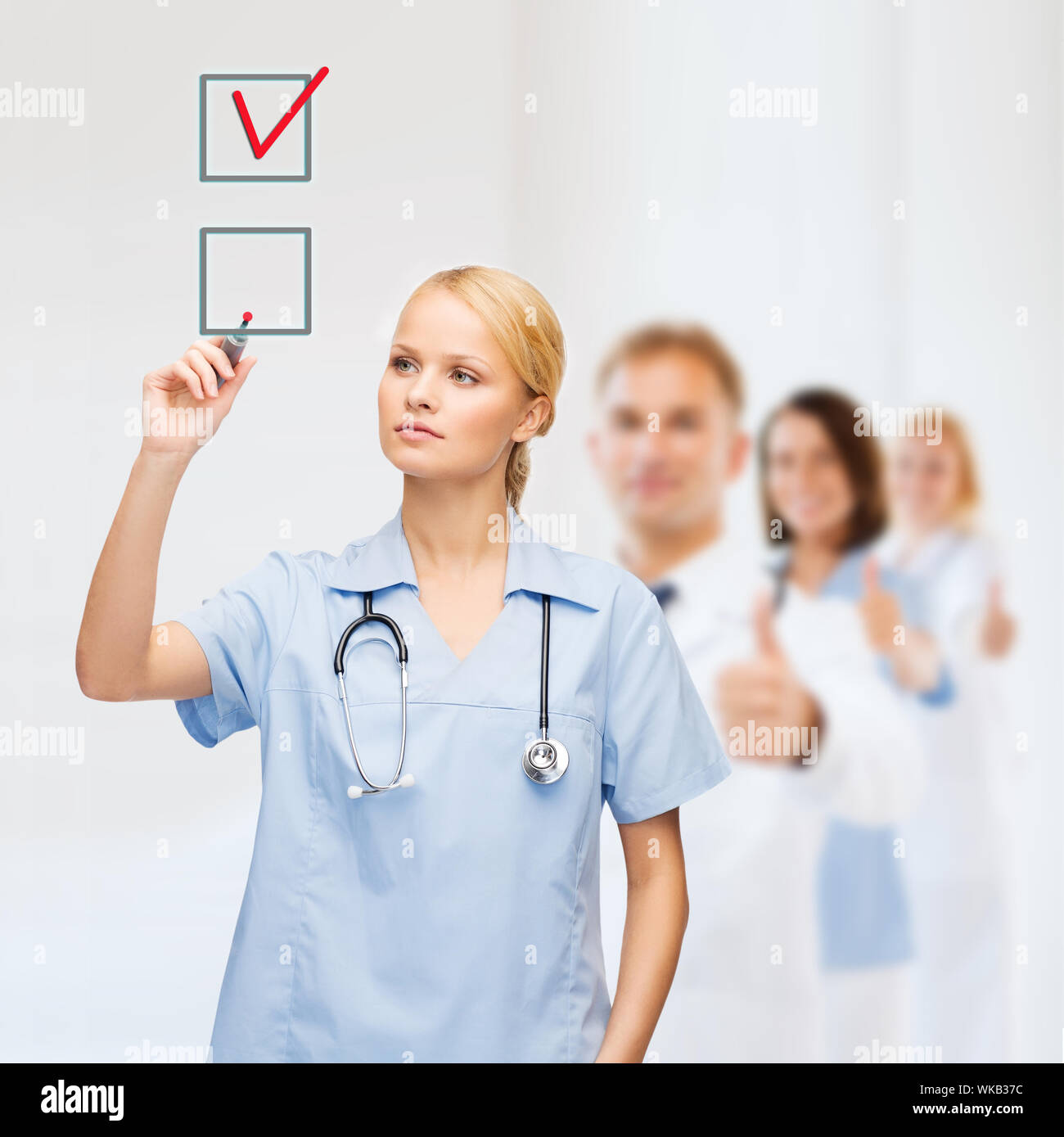 doctor or nurse drawning checkmark into checkbox Stock Photo - Alamy