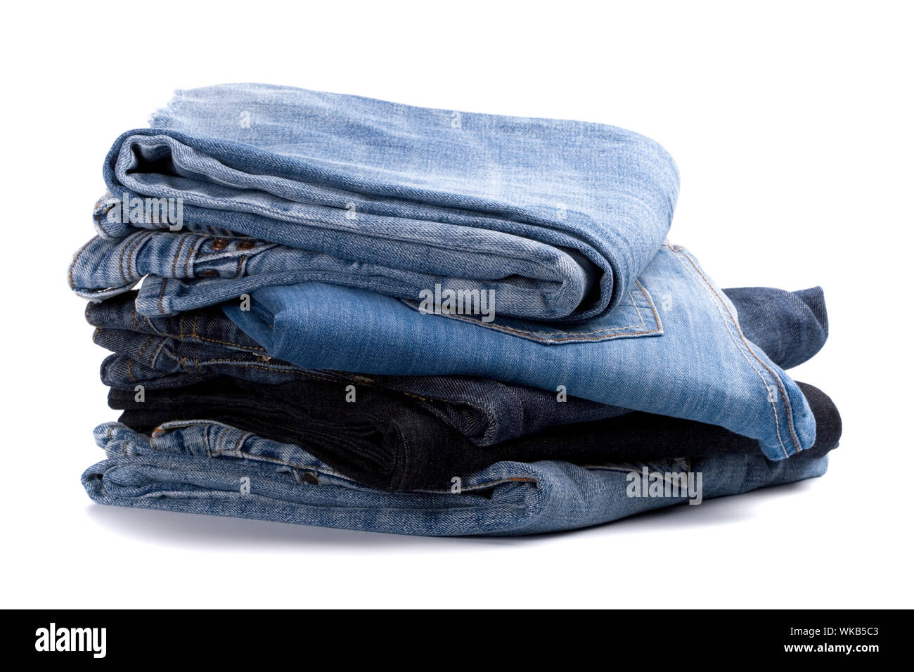 stack of blue jeans isolated on white background Stock Photo - Alamy