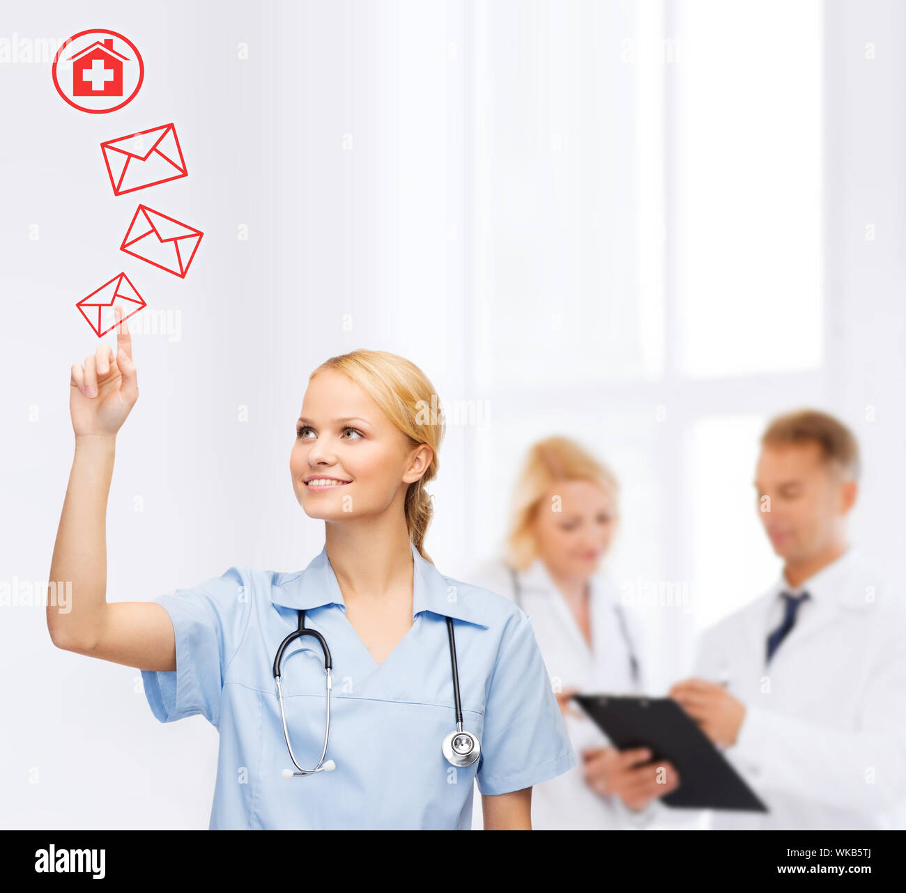 smiling doctor or nurse pointing to envelope Stock Photo - Alamy