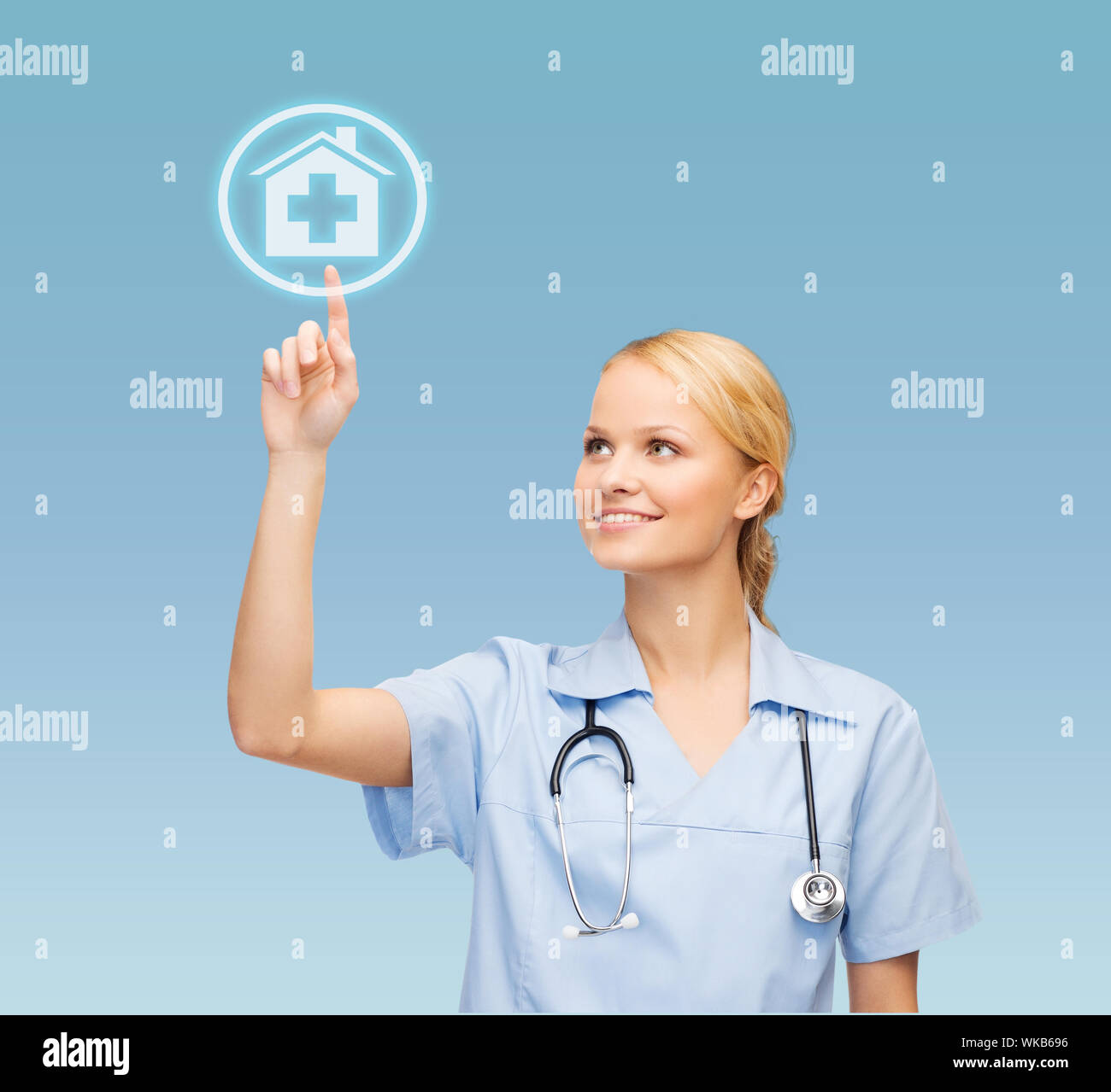 smiling doctor or nurse pointing to hospital icon Stock Photo - Alamy