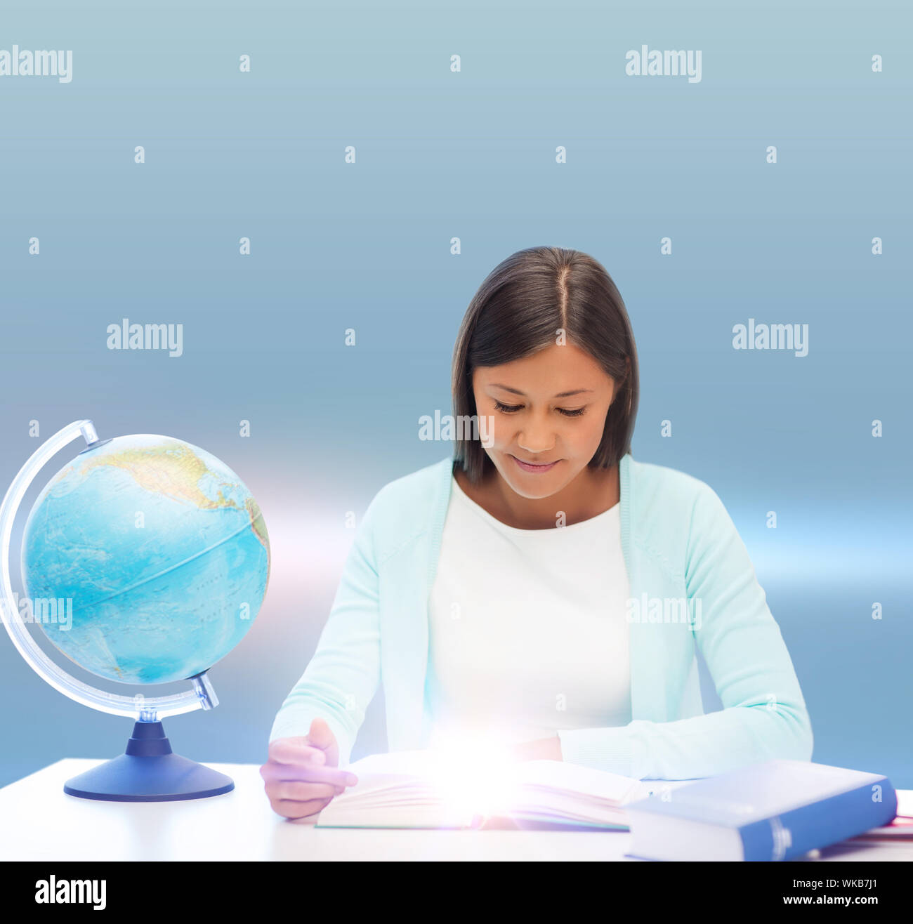 teacher with globe and book at school Stock Photo - Alamy