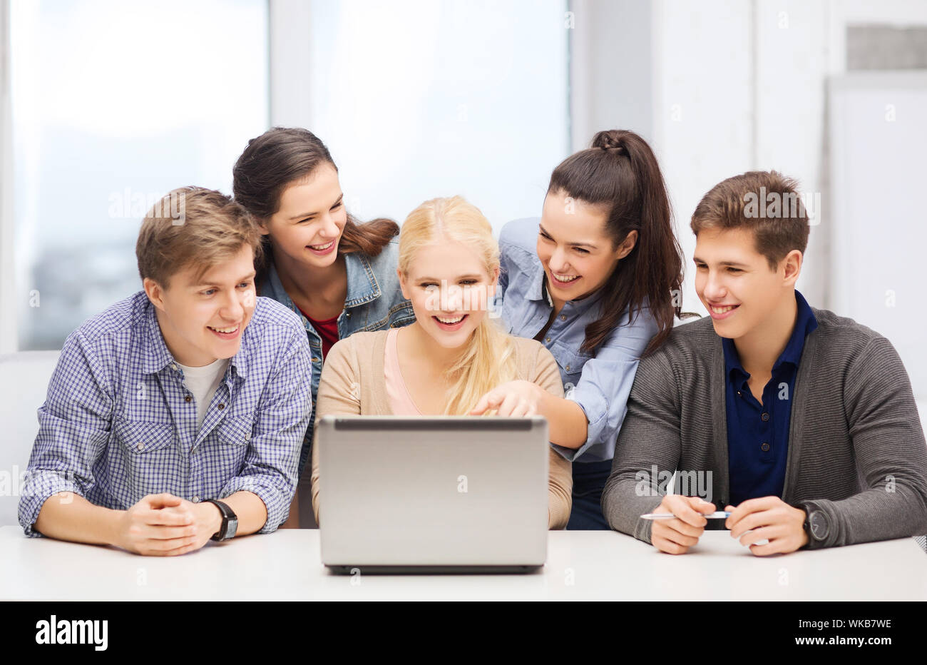 education, technology and internet concept - smiling students looking ...