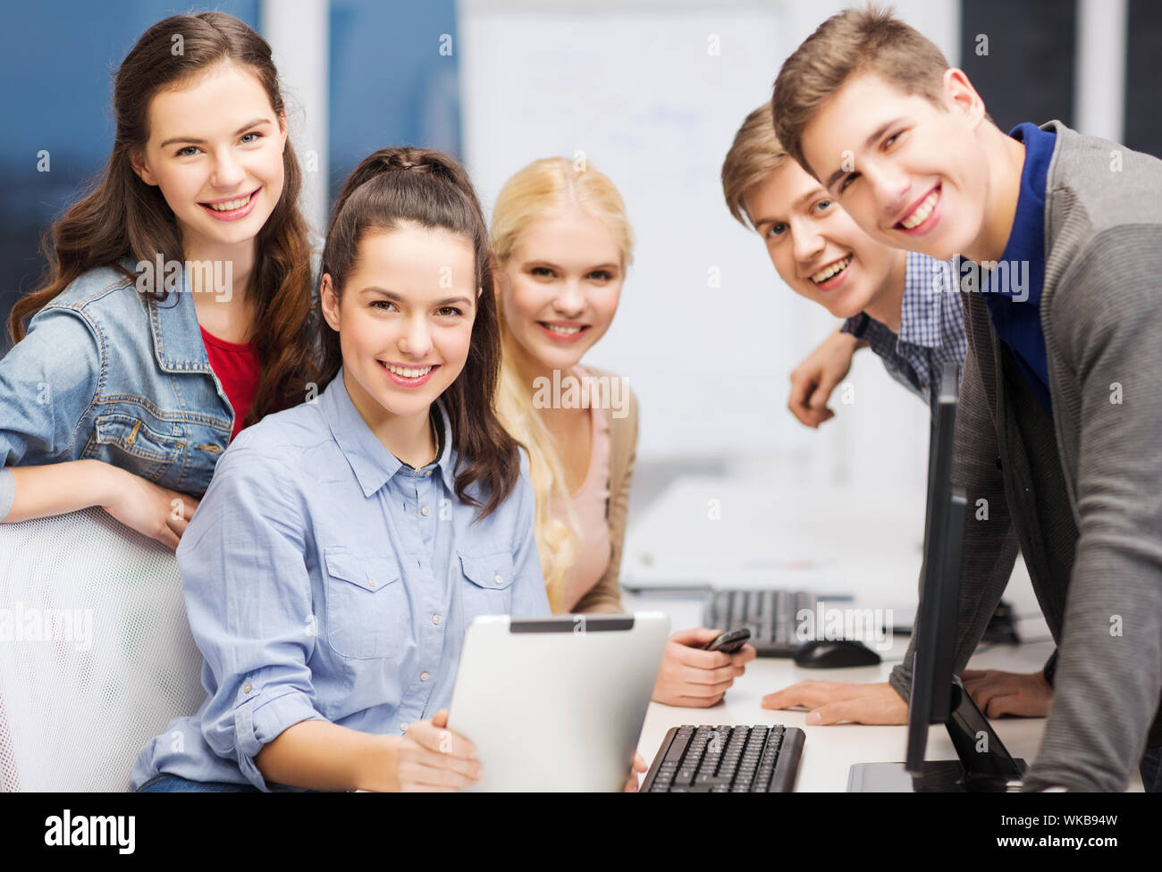 students with computer monitor and tablet pc Stock Photo - Alamy