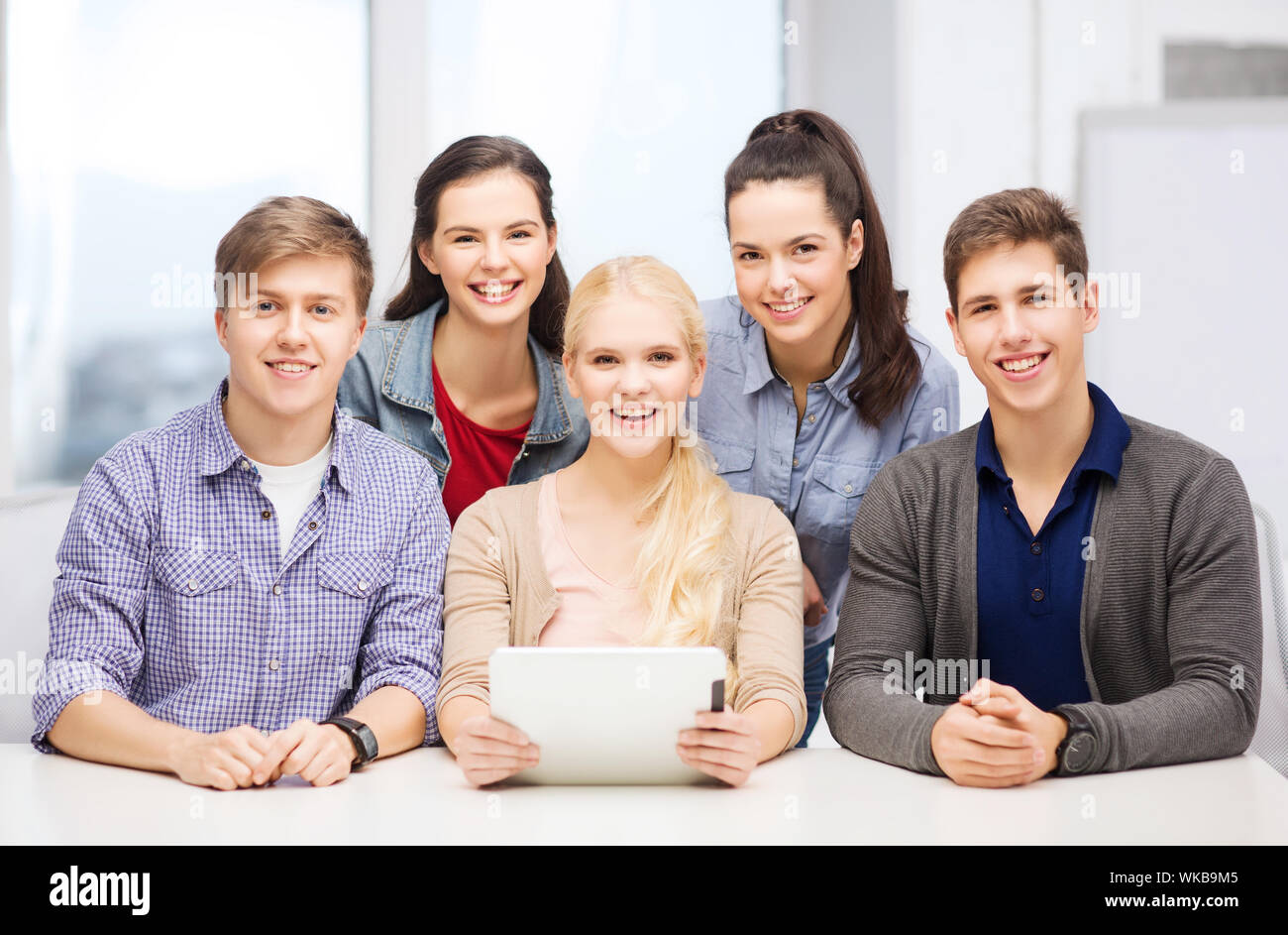 education, technology and internet concept - smiling students with ...