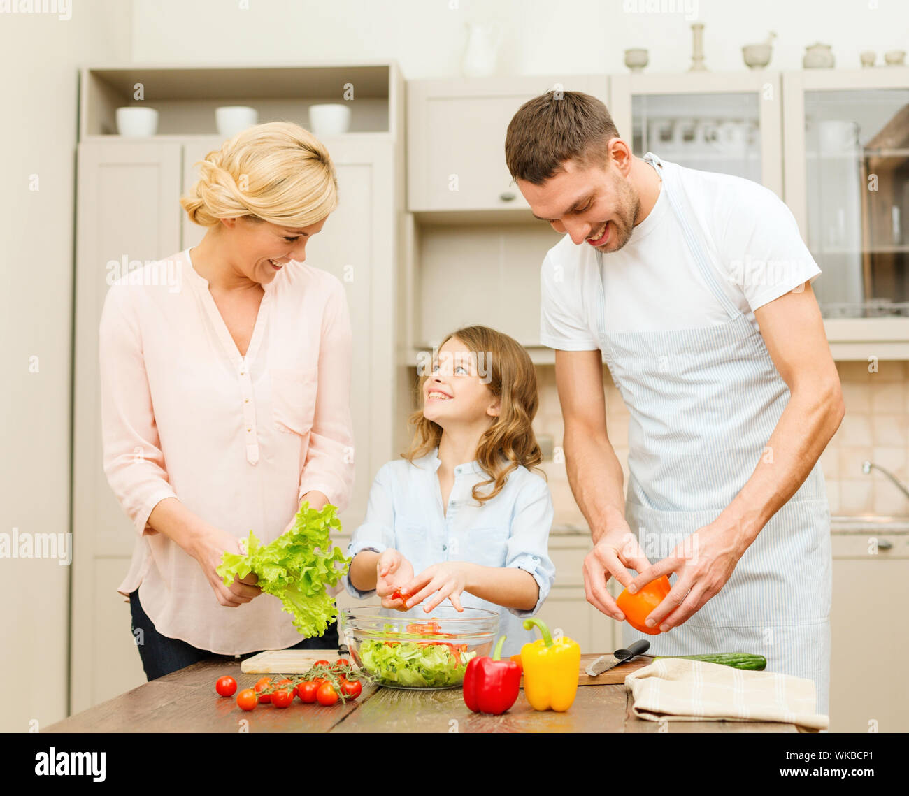 happy family making dinner in kitchen Stock Photo - Alamy