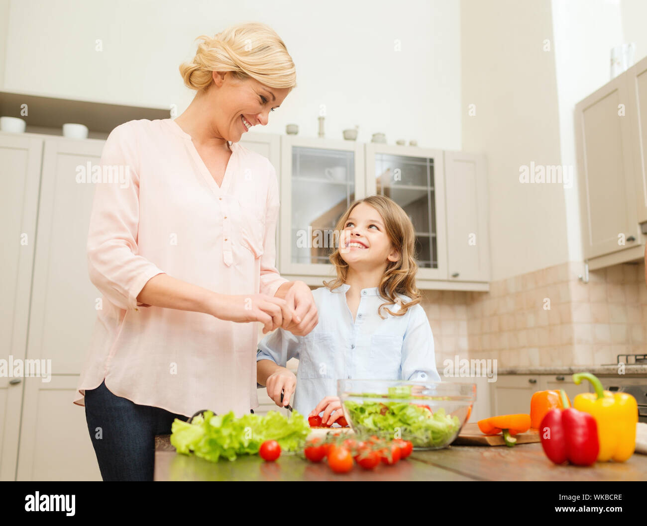 happy family making dinner in kitchen Stock Photo - Alamy