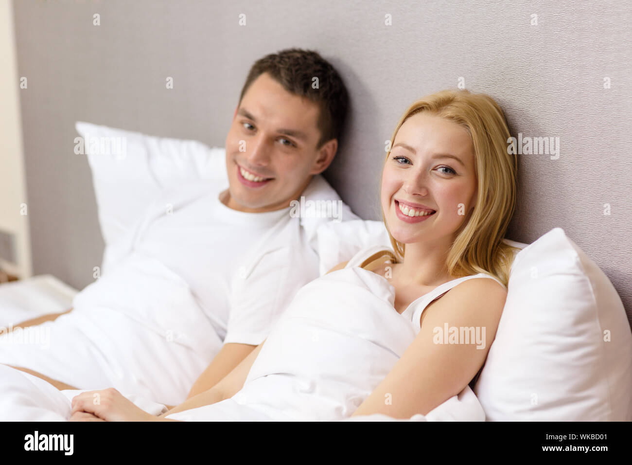 happy couple sleeping in bed Stock Photo - Alamy