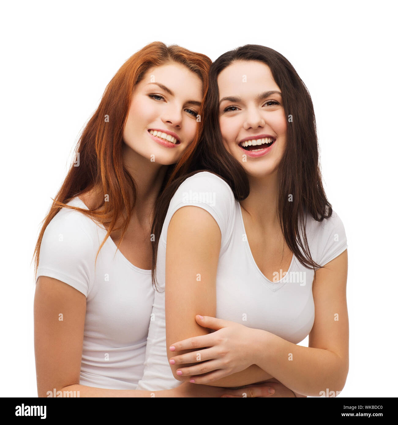 two laughing girls in white t-shirts hugging Stock Photo - Alamy